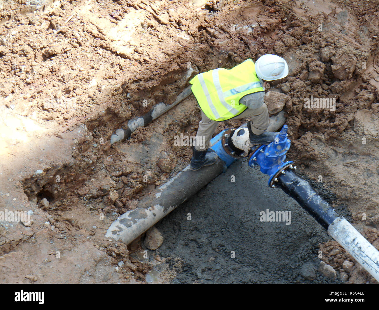SELANGOR, MALAYSIA -MARCH 18, 2017: Construction workers install precast underground drain at ...