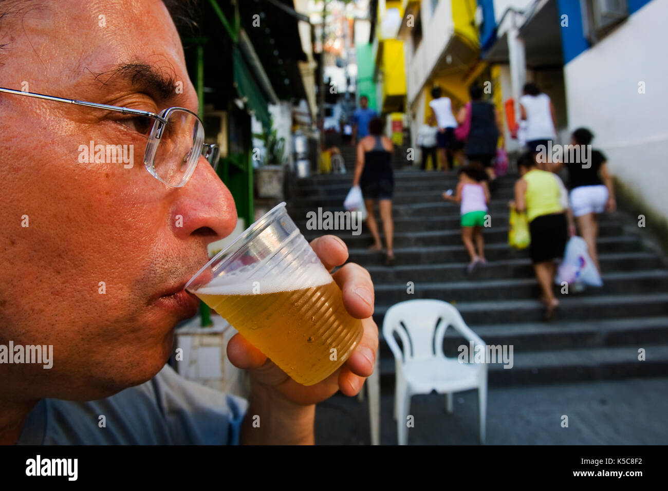 Man drinking beer at Morro Dona Marta one of the many favelas in Rio de ...