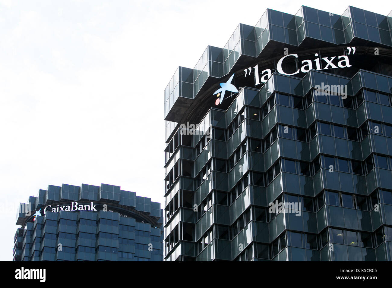 A logo sign outside of the headquarters of the La Caixa group and Caixa ...