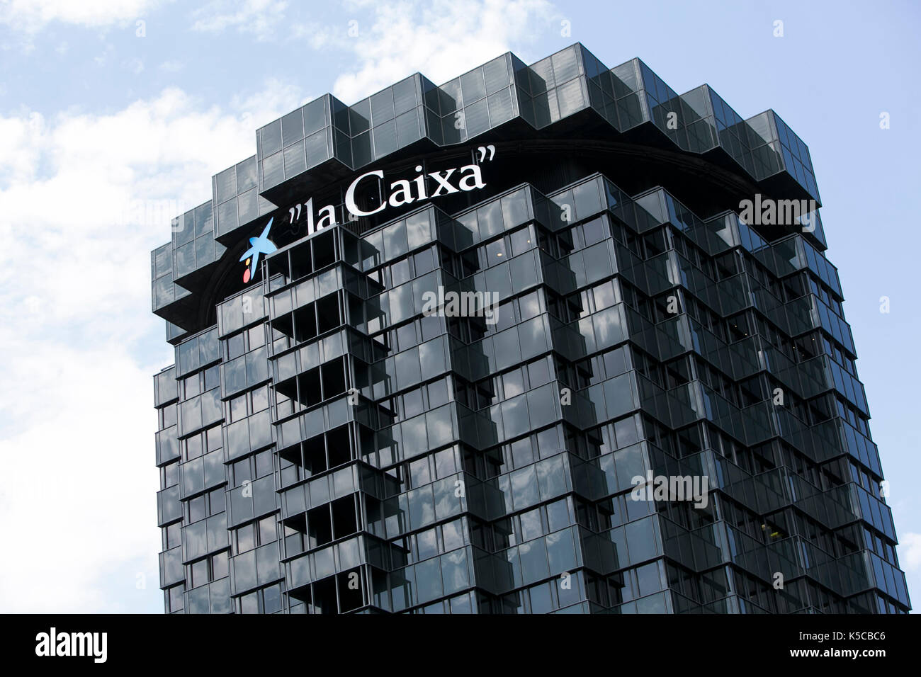 A logo sign outside of the headquarters of the La Caixa group and Caixa ...