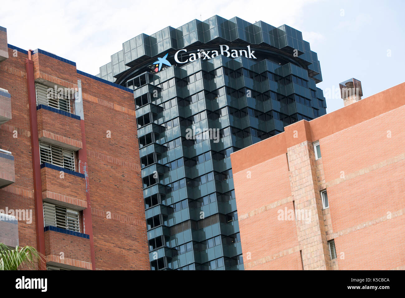 A logo sign outside of the headquarters of the La Caixa group and Caixa ...
