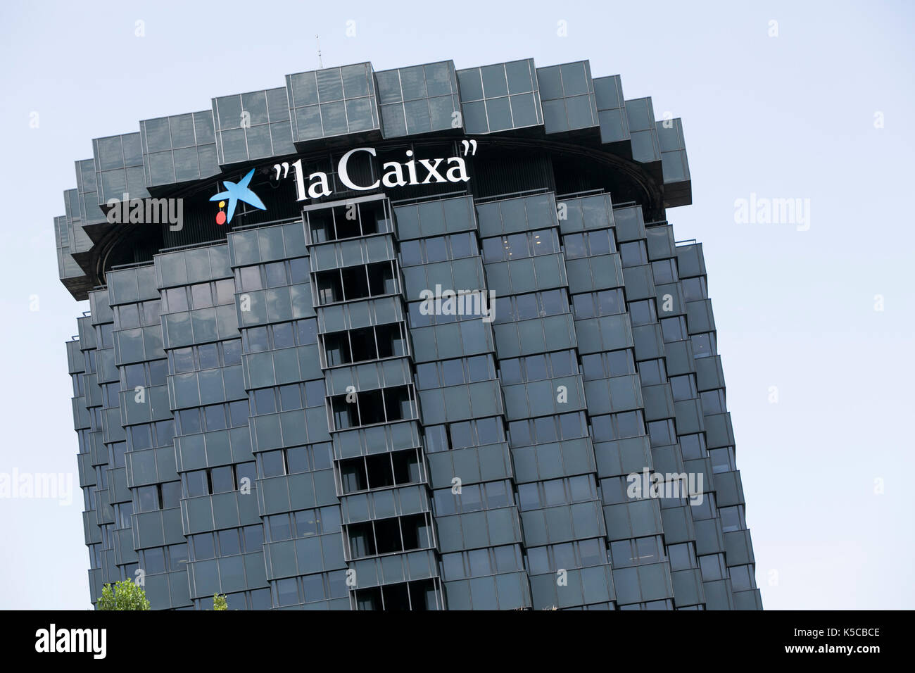 A logo sign outside of the headquarters of the La Caixa group and Caixa ...