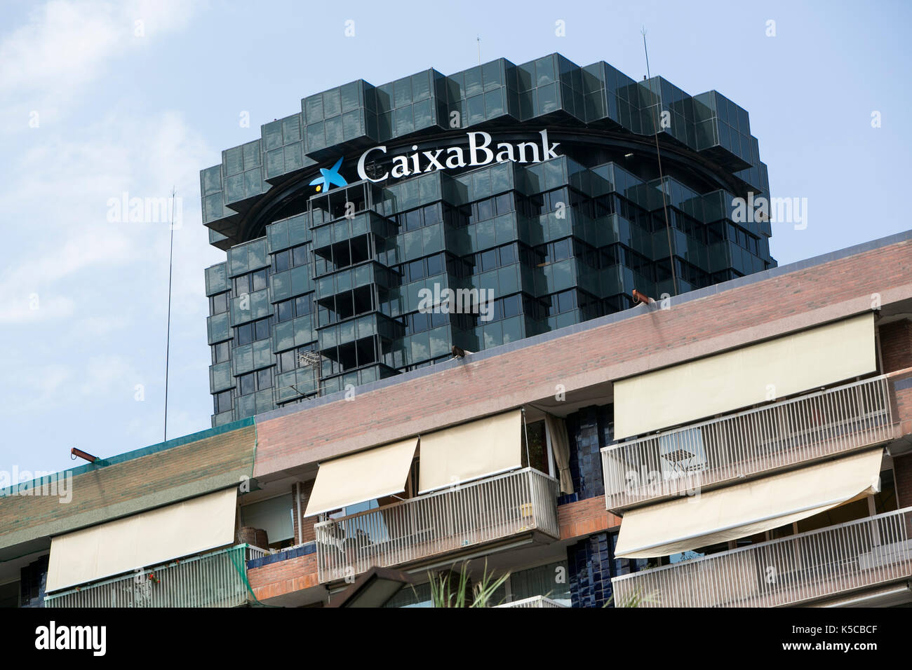 A logo sign outside of the headquarters of the La Caixa group and Caixa ...