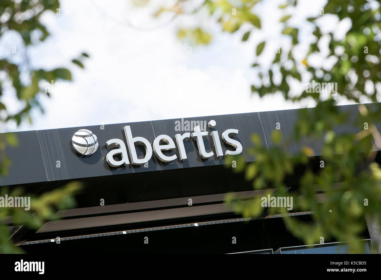 A logo sign outside of the headquarters of Abertis Infraestructuras in ...