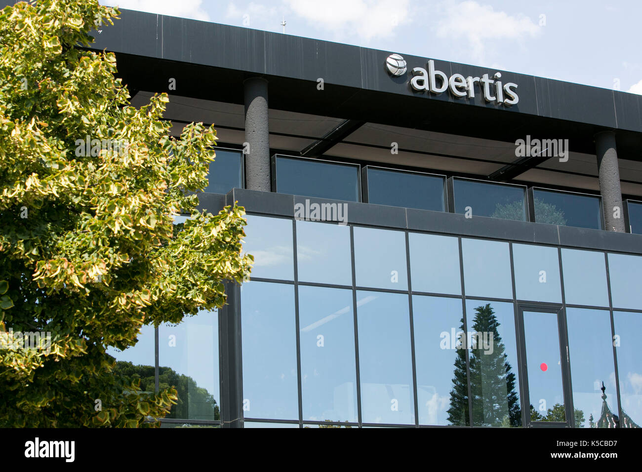 A logo sign outside of the headquarters of Abertis Infraestructuras in ...