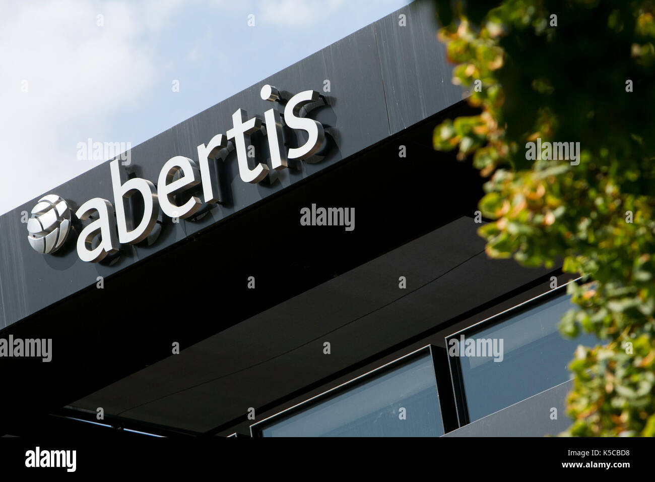 A logo sign outside of the headquarters of Abertis Infraestructuras in ...