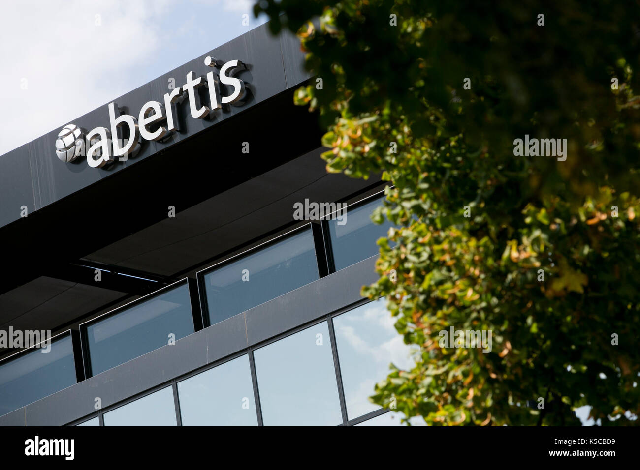 A logo sign outside of the headquarters of Abertis Infraestructuras in ...
