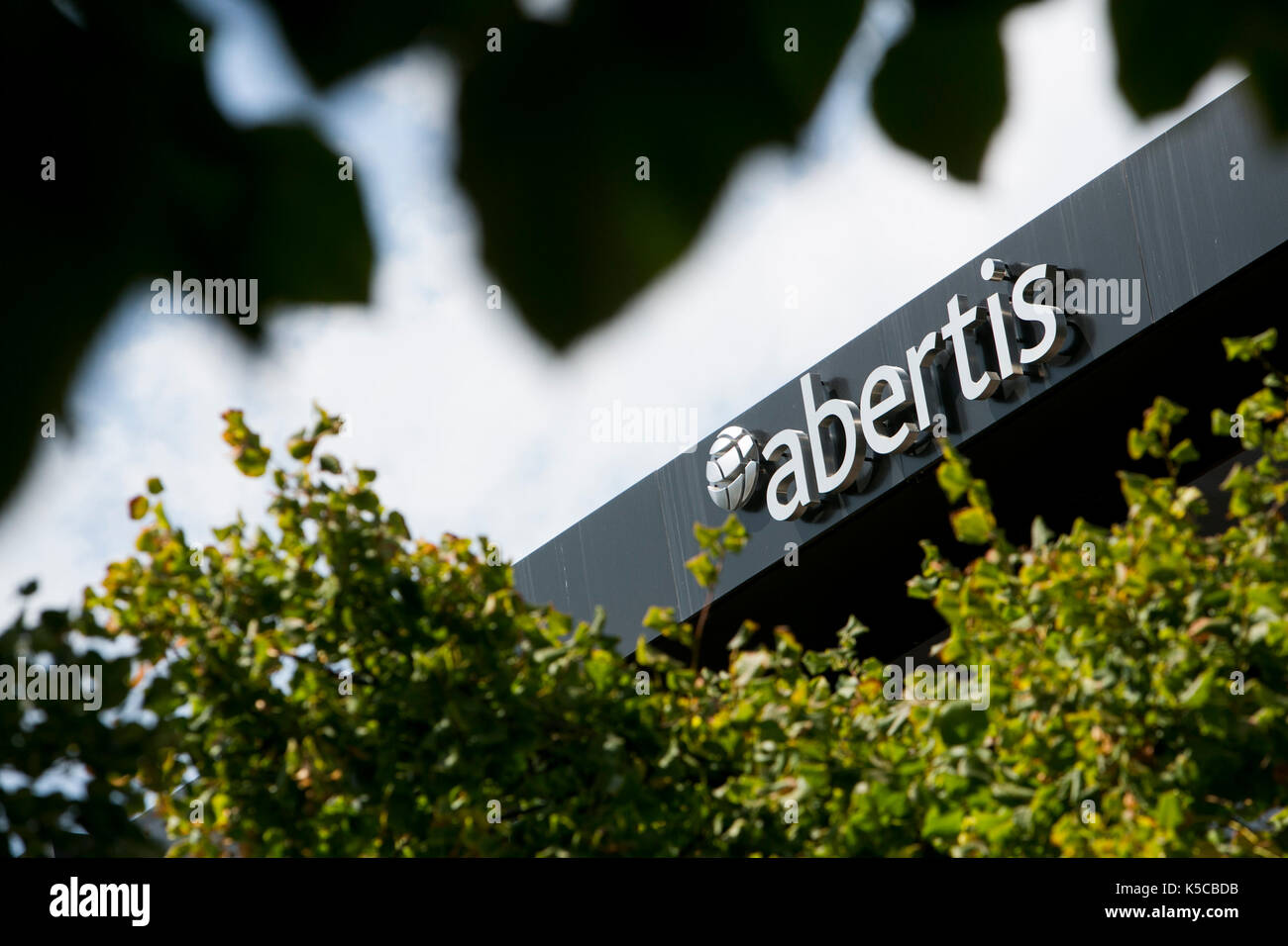 A logo sign outside of the headquarters of Abertis Infraestructuras in ...