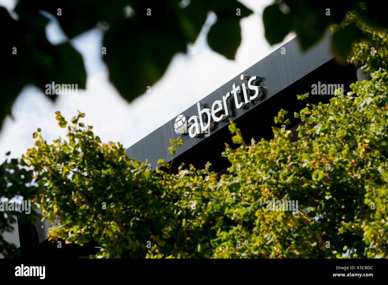 A logo sign outside of the headquarters of Abertis Infraestructuras in ...
