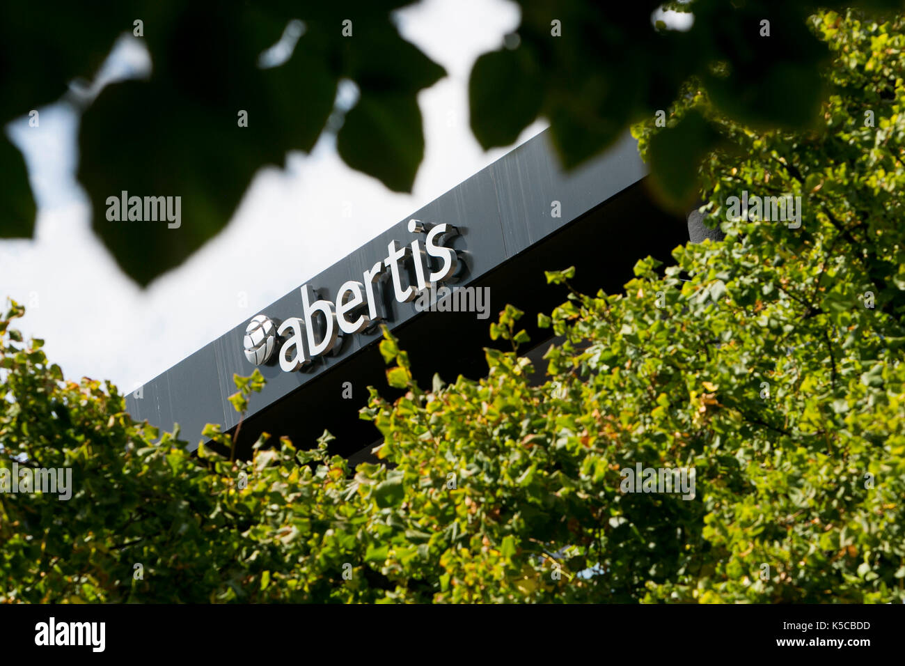 A logo sign outside of the headquarters of Abertis Infraestructuras in ...