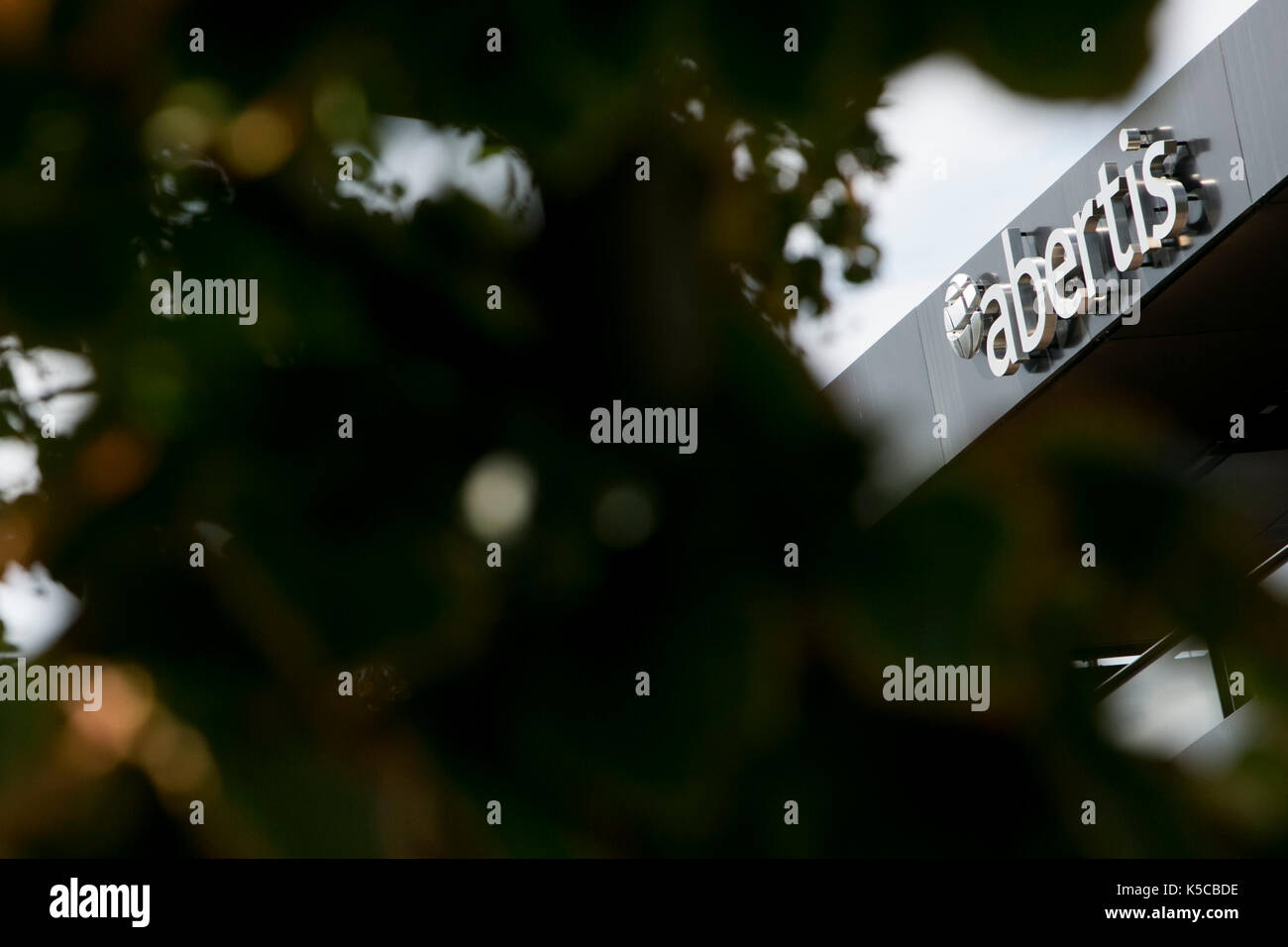 A logo sign outside of the headquarters of Abertis Infraestructuras in ...