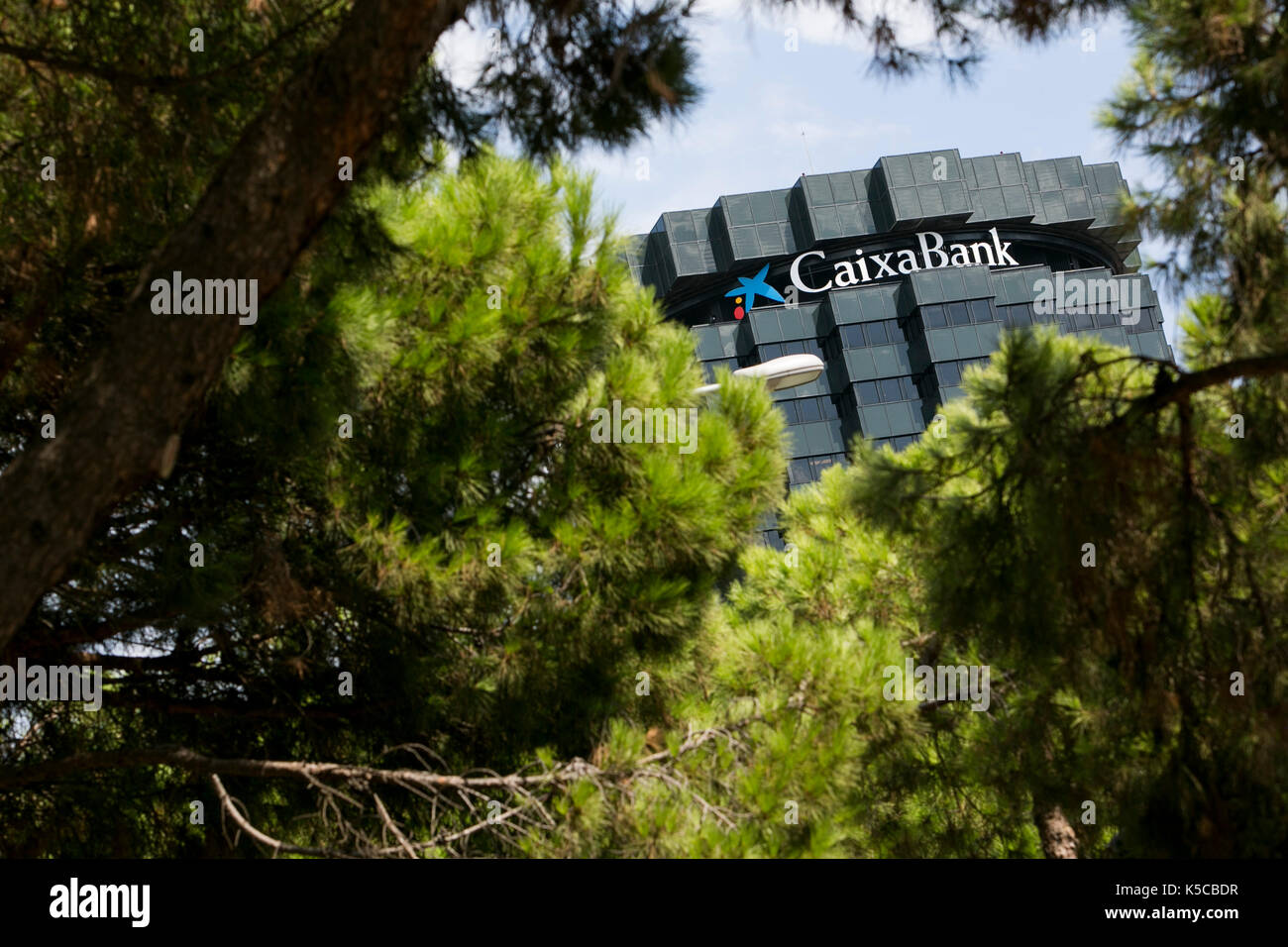 A logo sign outside of the headquarters of the La Caixa group and Caixa ...