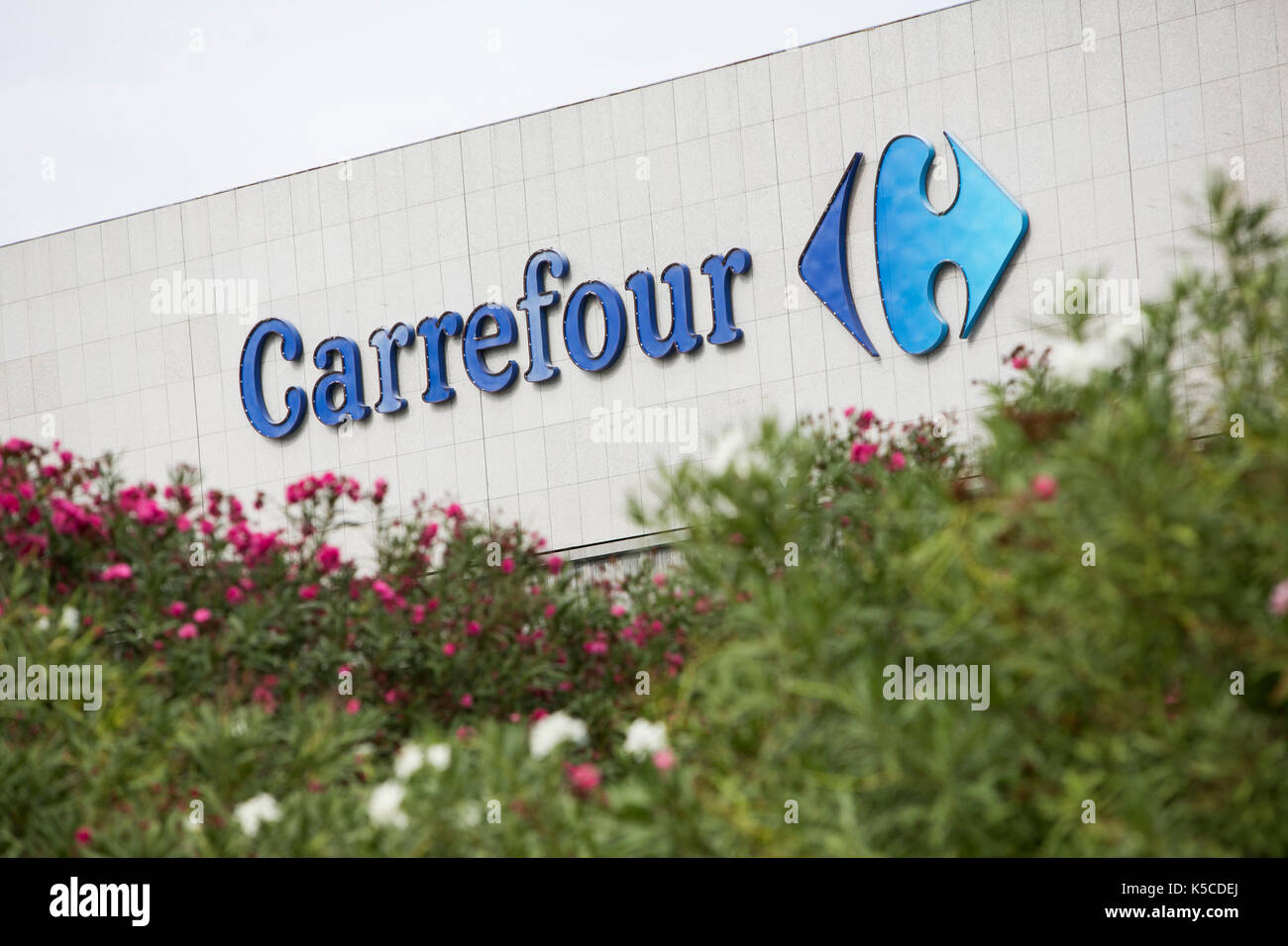 A logo sign outside of a Carrefour retail store in Barcelona, Spain on ...