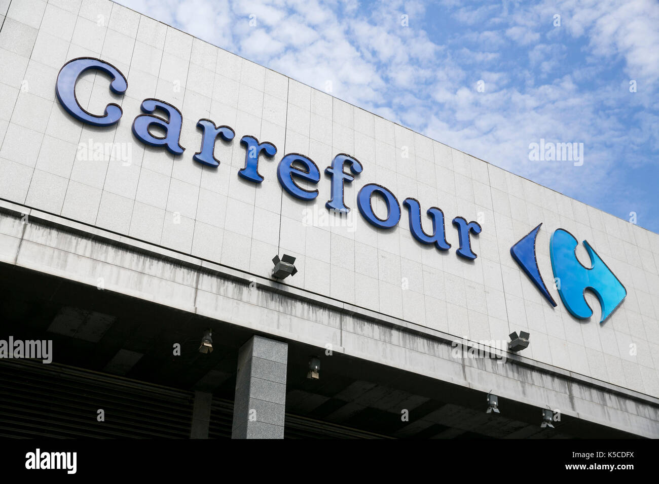 A logo sign outside of a Carrefour retail store in Barcelona, Spain on ...