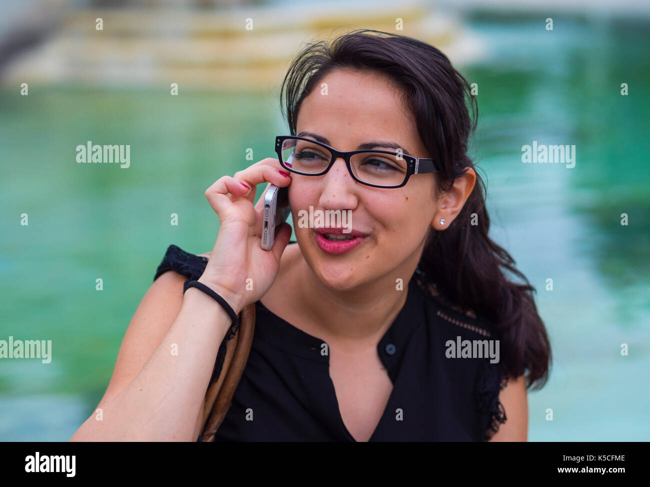 Young Turkish girl is taking a phone call Stock Photo - Alamy