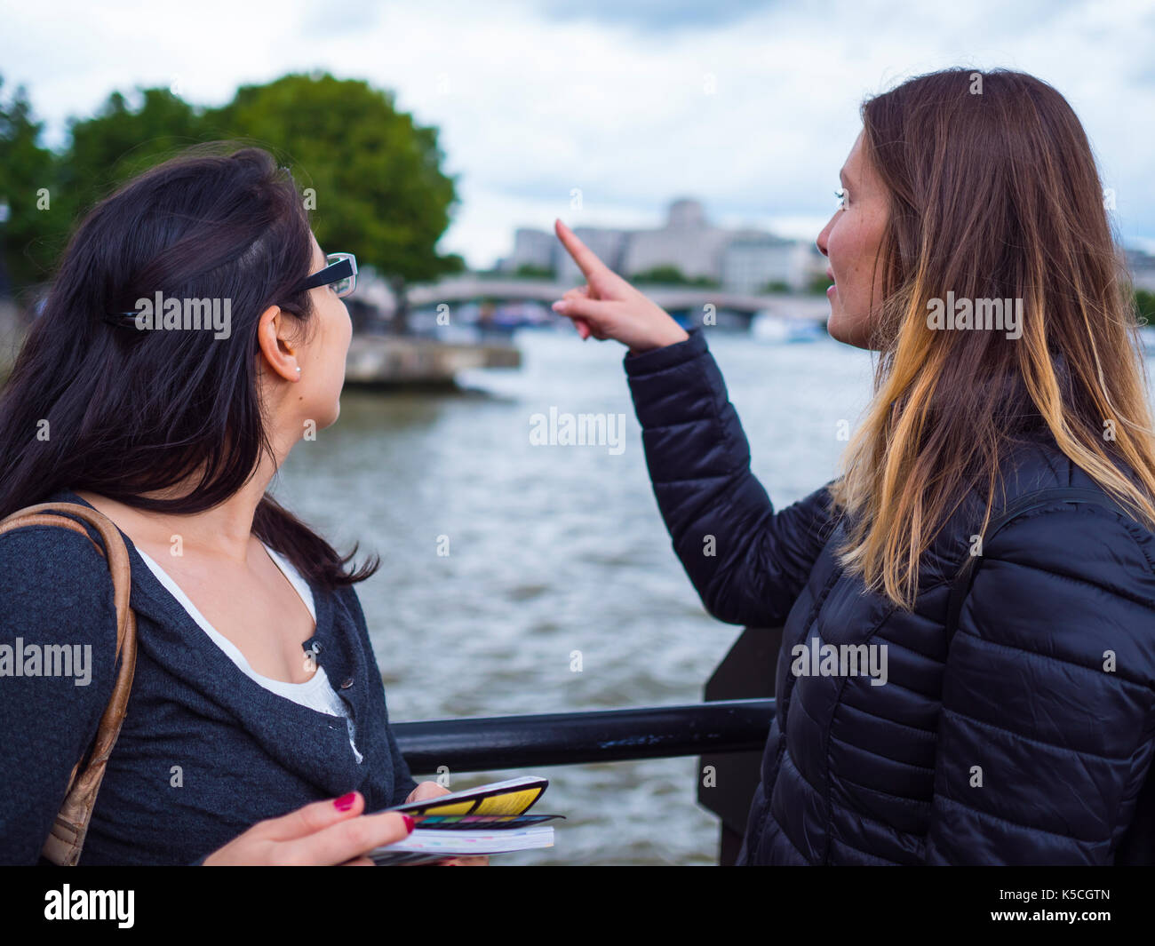 Two girls at River Thames in London explore the city Stock Photo - Alamy
