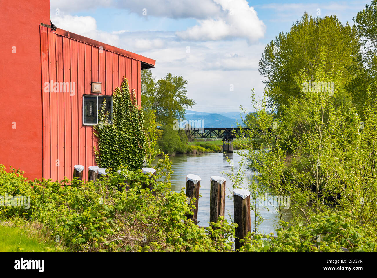 Rural Landscape Burnt Orange Building alongside River with Rairoad ...