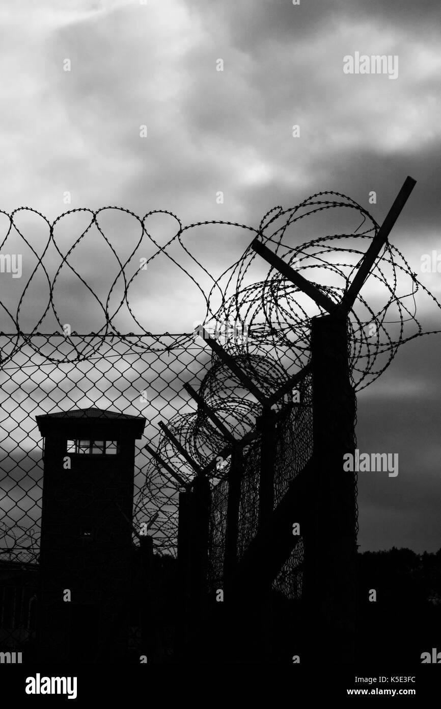 A highly secure prison with razor wire fence and a watchtower Stock ...