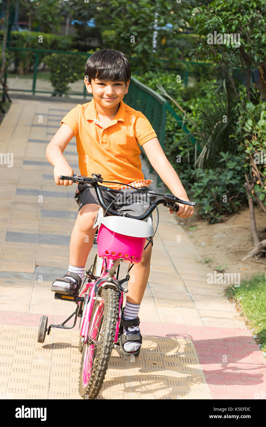 happy 1 Kid Boy have fun in Park and learning to ride his first Bicycle ...