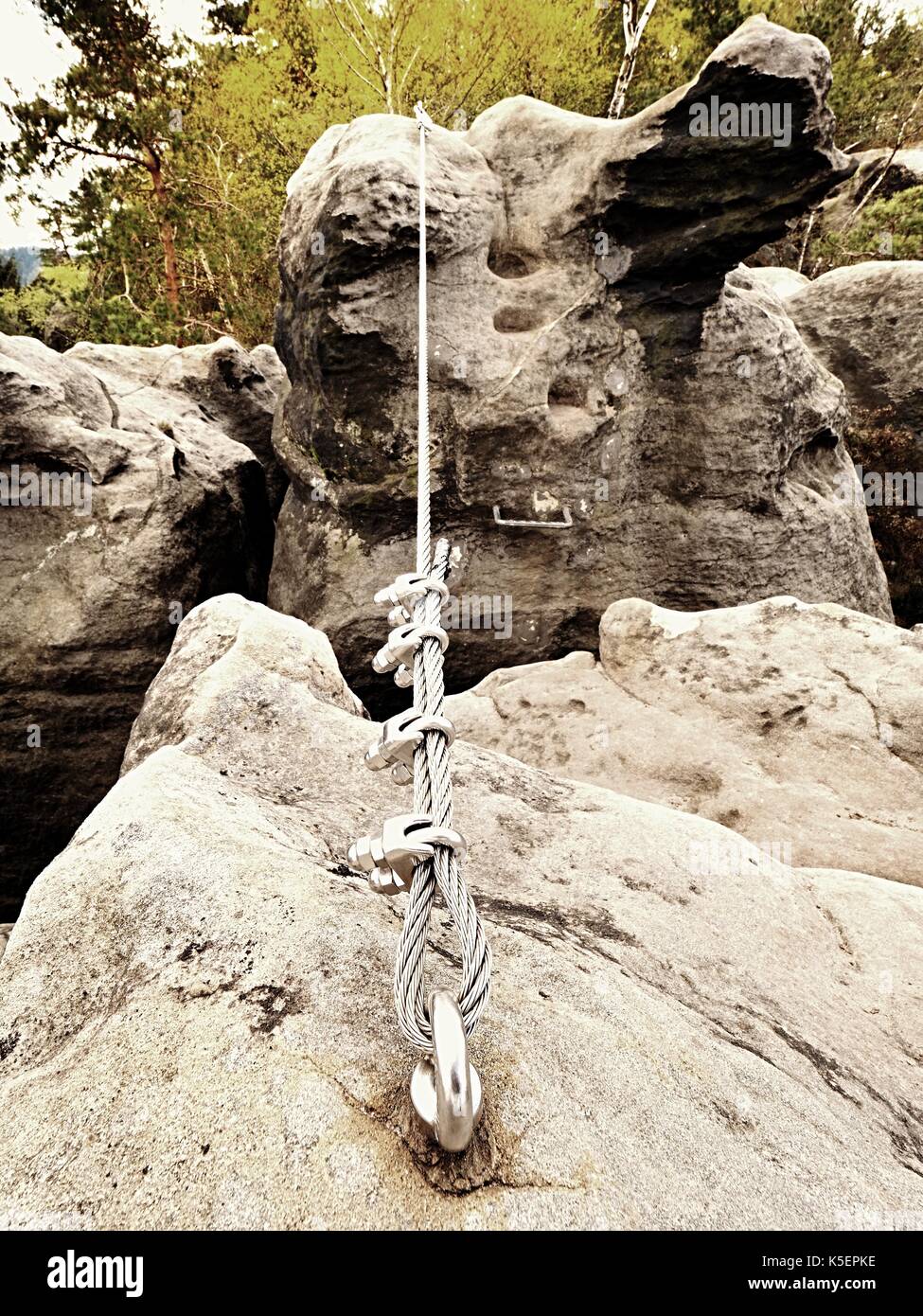 Iron twisted rope stretched between rocks in climbers patch via ferrata ...