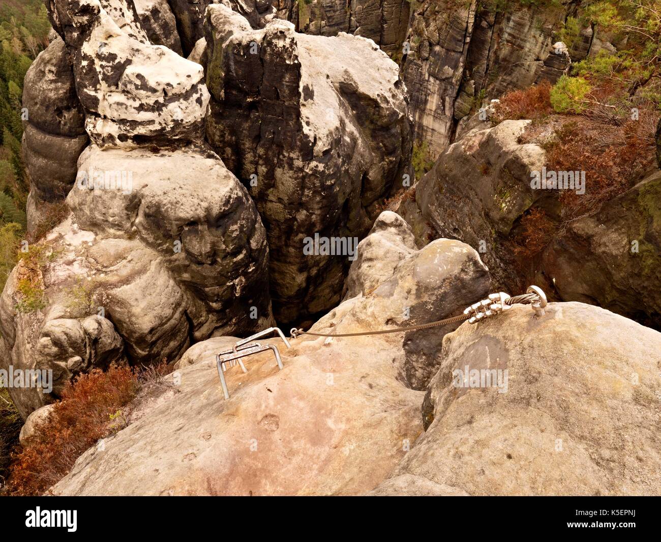 Climbers ladder. Iron twisted rope fixed in block by screws snap hooks ...