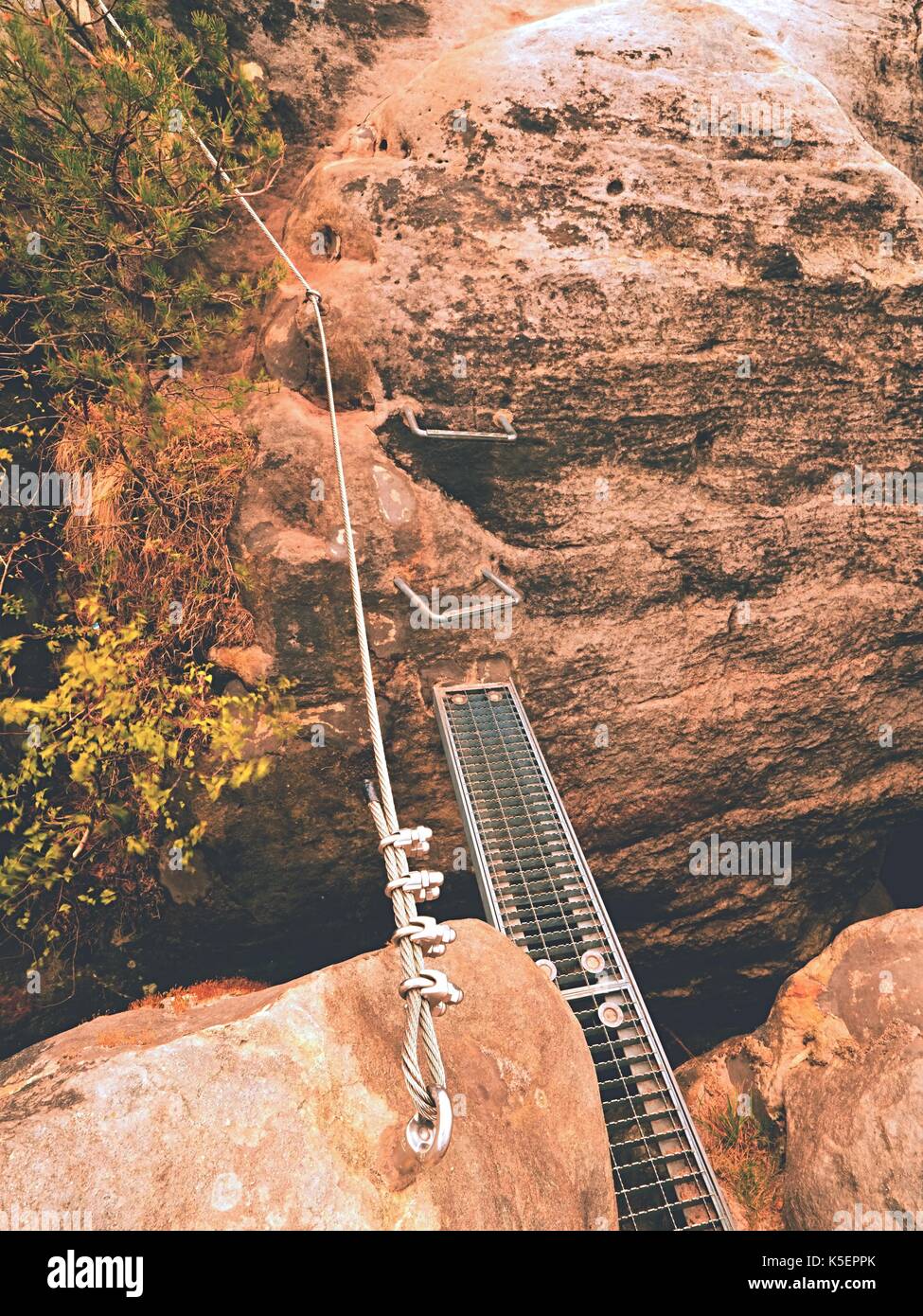 Steel ladder way, steel ramp between rocks via ferrata. Iron twisted ...