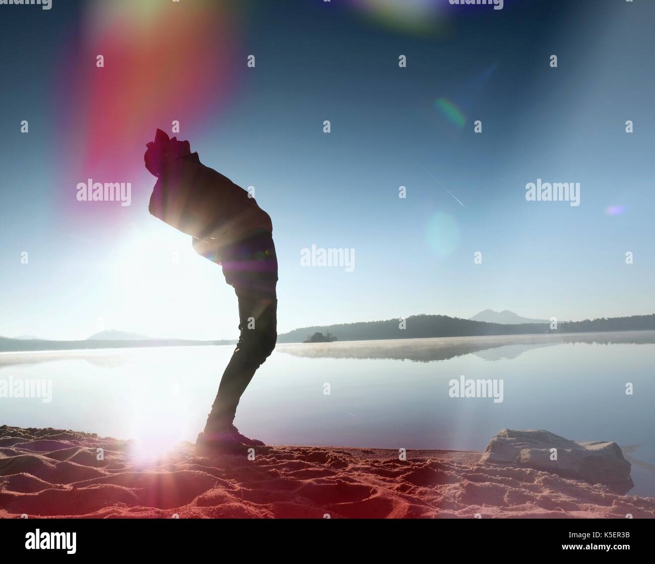 Athlete man is bending back. Bend and stretch back muscles within ...