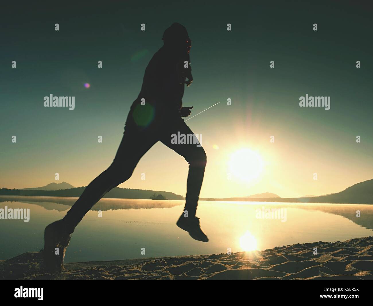 Running man on beach. Sportsman run in baseball cap, jogging guy during ...