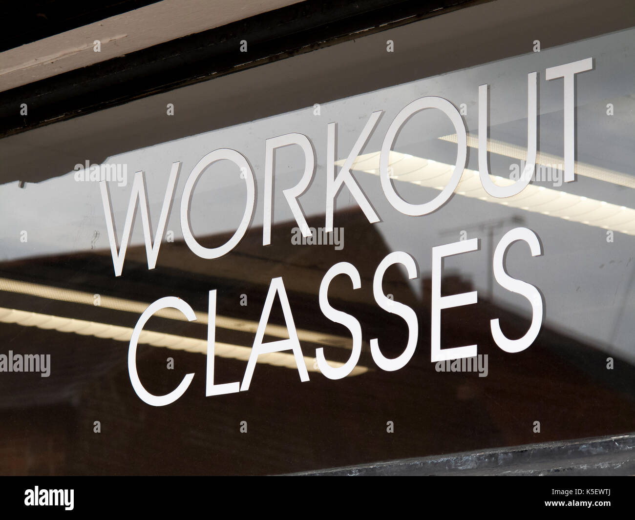 Workout classes sign in gymnasium window Stock Photo - Alamy