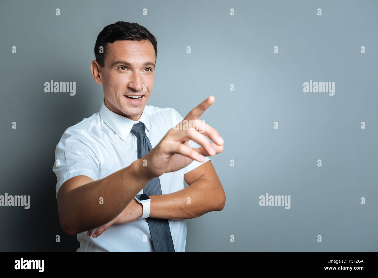 Delighted positive man pointing forward Stock Photo - Alamy