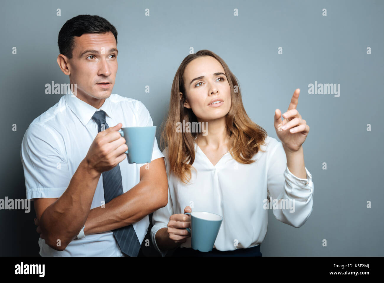Nice young colleagues having tea Stock Photo - Alamy