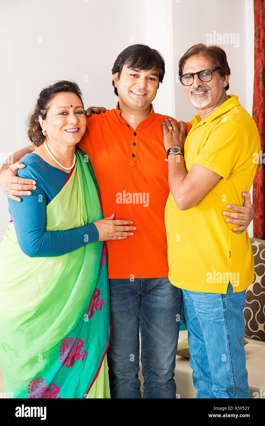 Indian Adult Son And Senior Parents Standing Together at home Stock ...