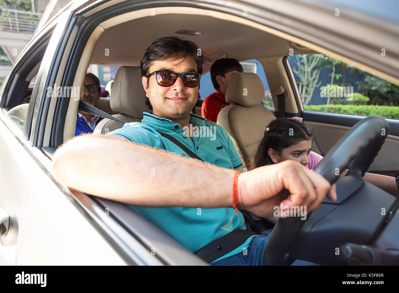 Indian Father and Kids sitting New Car driving Bank Loan Stock Photo ...