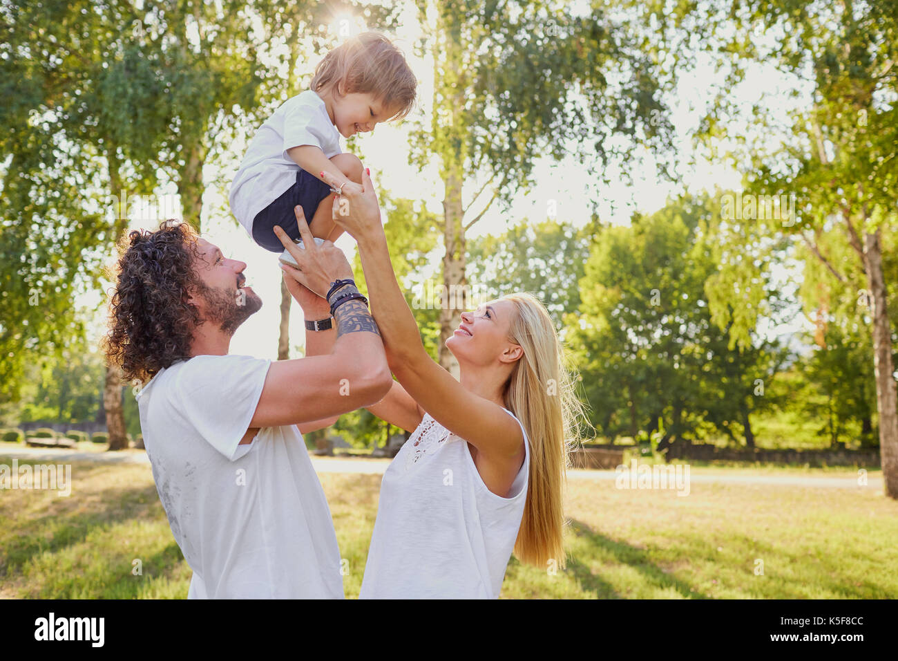Happy family playing in the park Stock Photo - Alamy