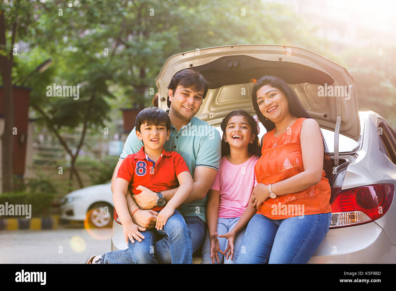 Happy Indian Family sitting at the back of a car Enjoying Stock Photo - Alamy