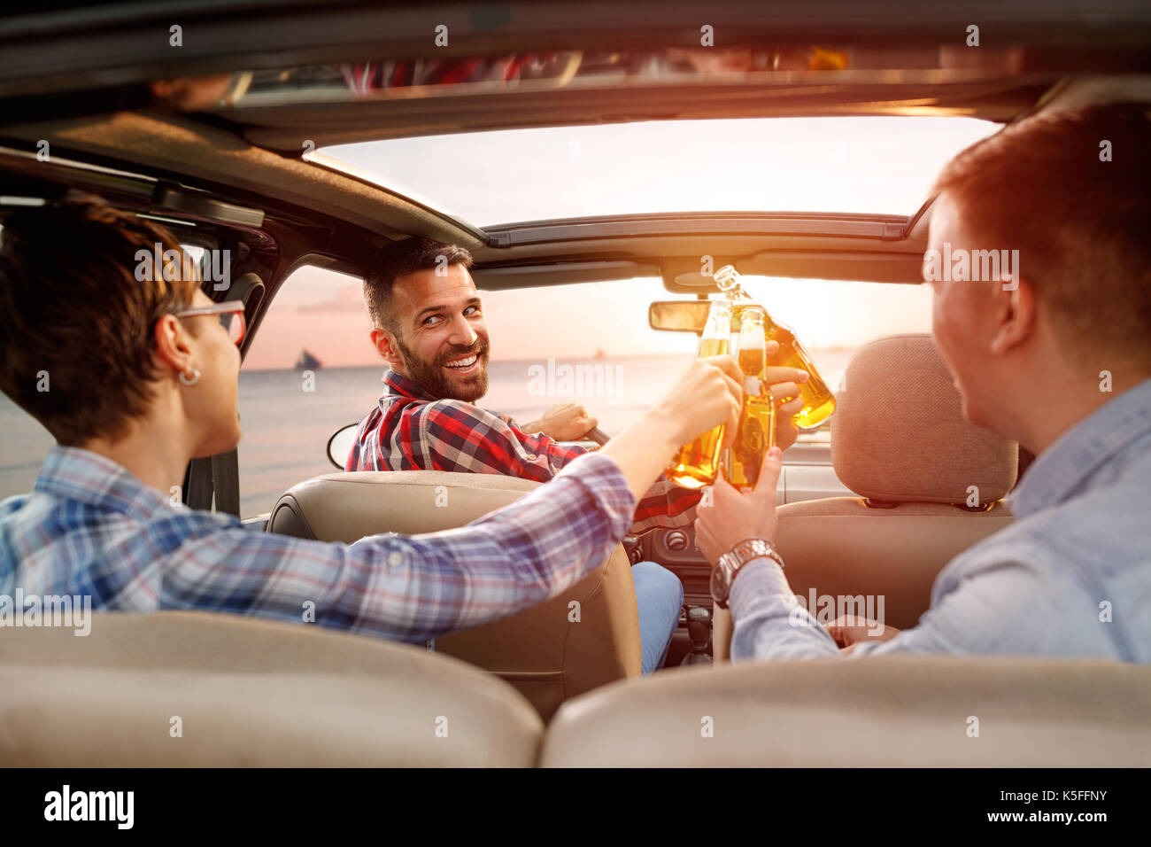 Young friends enjoying a road trip in the car Stock Photo - Alamy