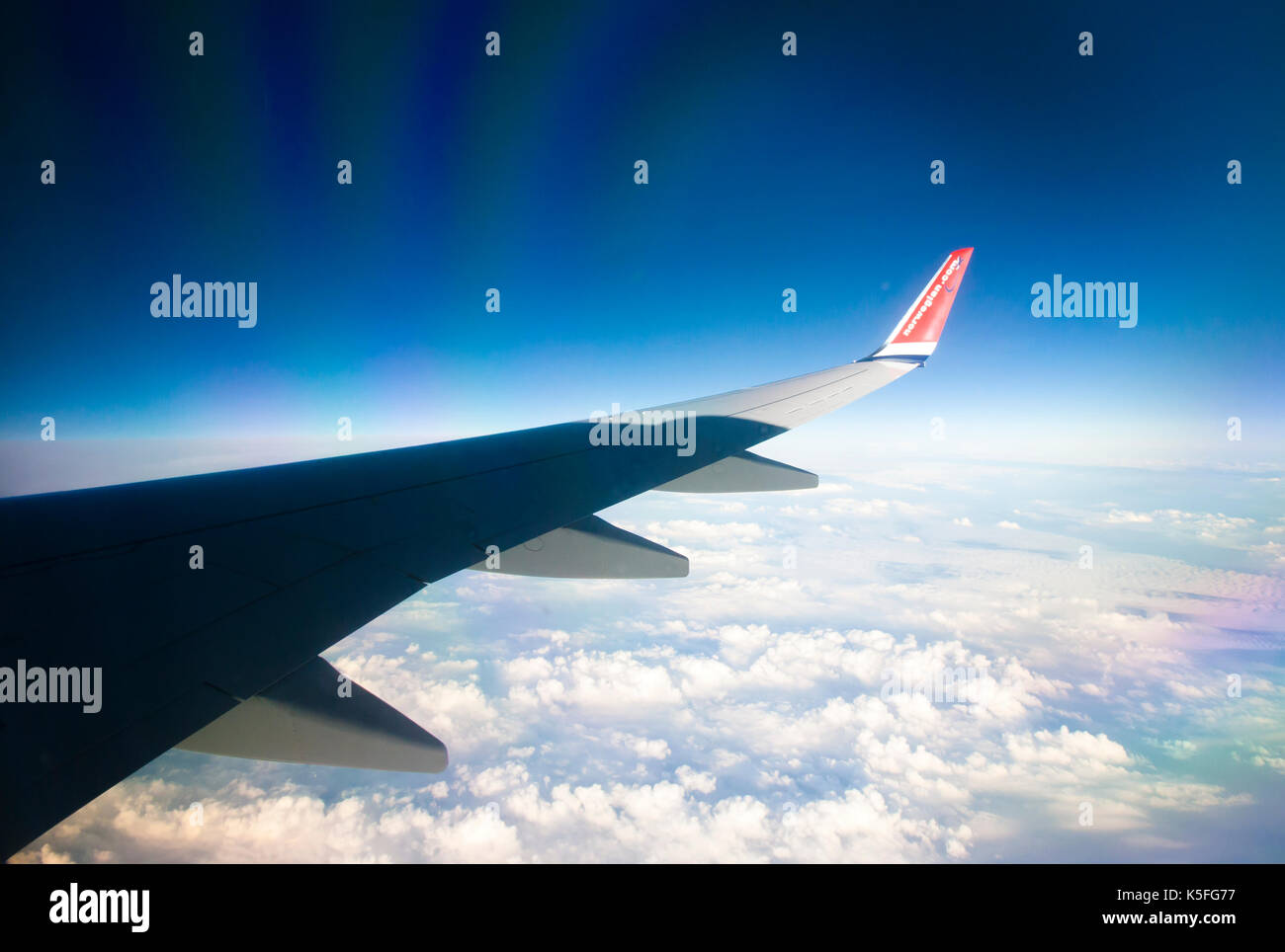 View from Norwegian airplane window with blue sky and white clouds. 08. ...