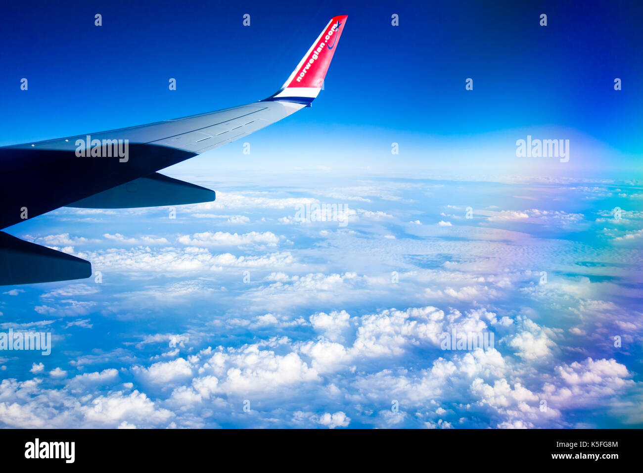 View from Norwegian airplane window with blue sky and white clouds. 08. ...