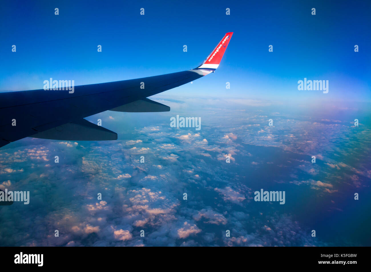 View from Norwegian airplane window with blue sky and white clouds. 08. ...