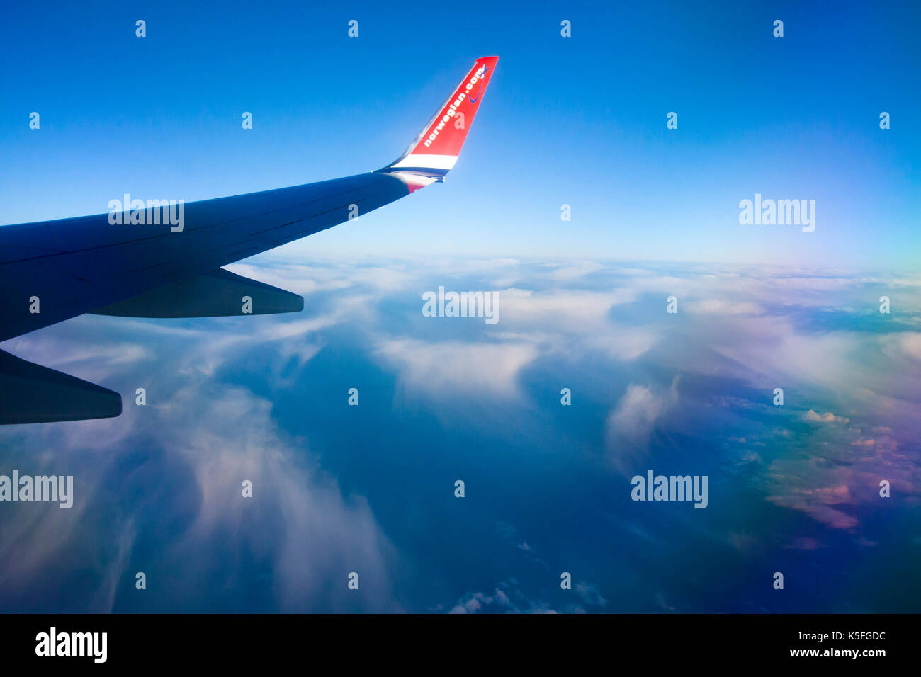 View from Norwegian airplane window with blue sky and white clouds. 08. ...