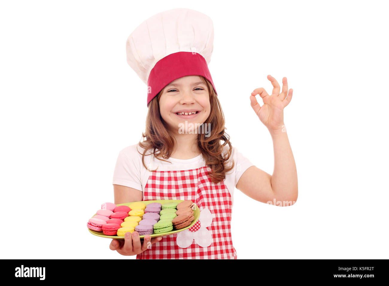 happy little girl cook with sweet macarons and ok hand sign Stock Photo ...