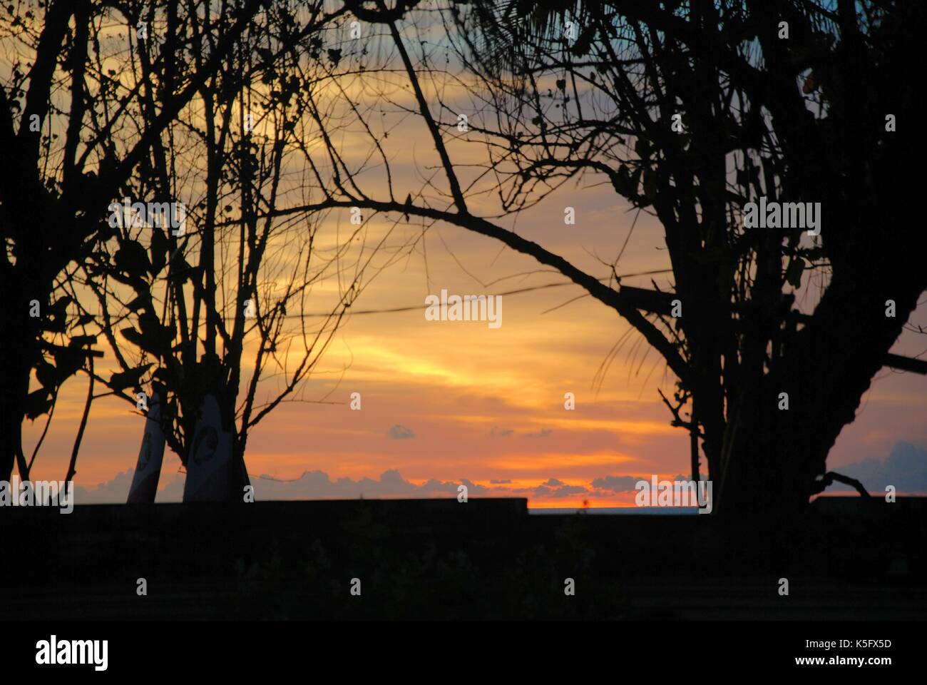sunset view of a beach in bali, indonesia Stock Photo - Alamy