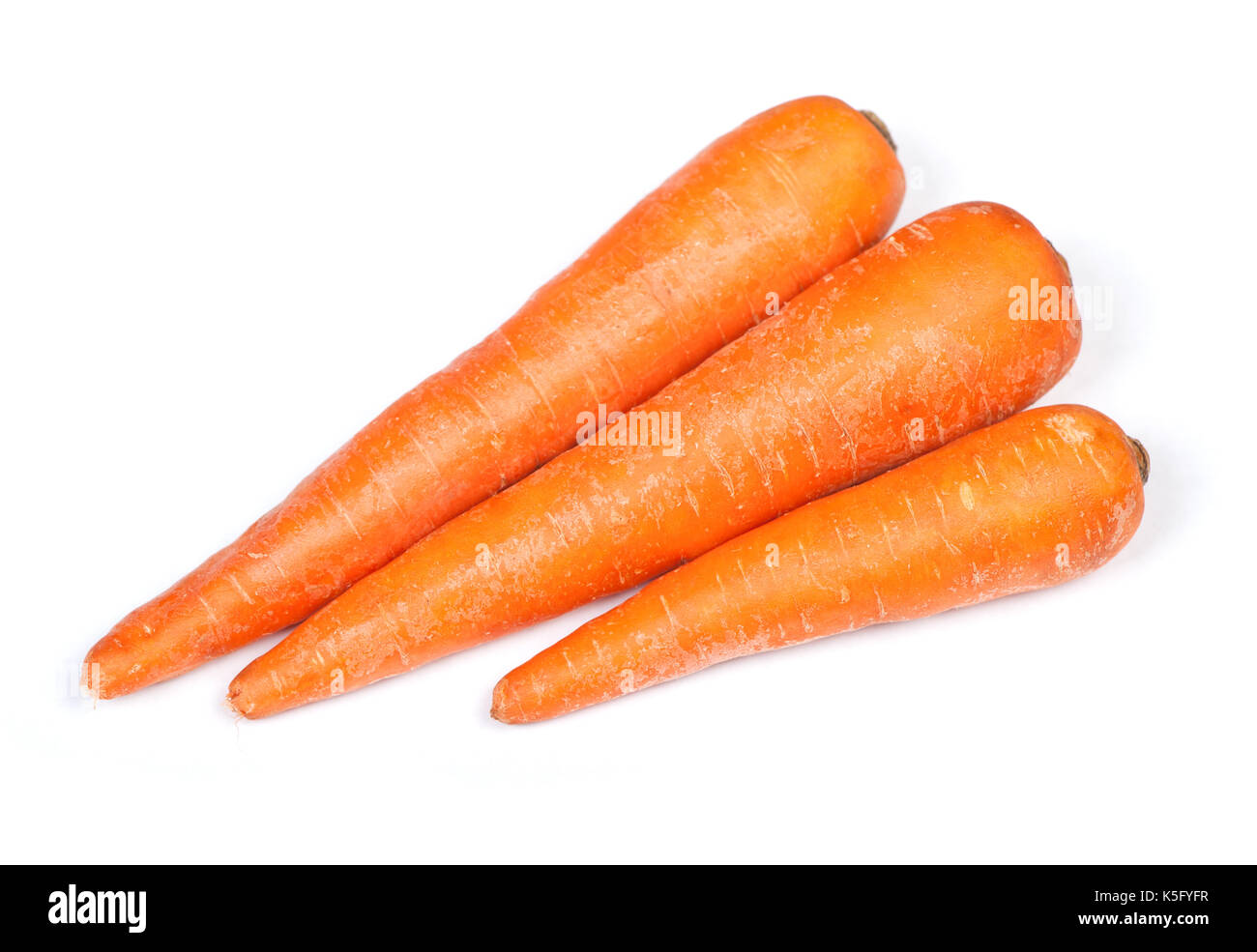 Three carrots isolated on white background Stock Photo - Alamy