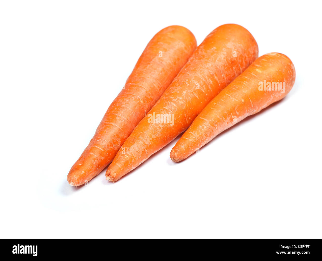Three carrots isolated on white background Stock Photo - Alamy