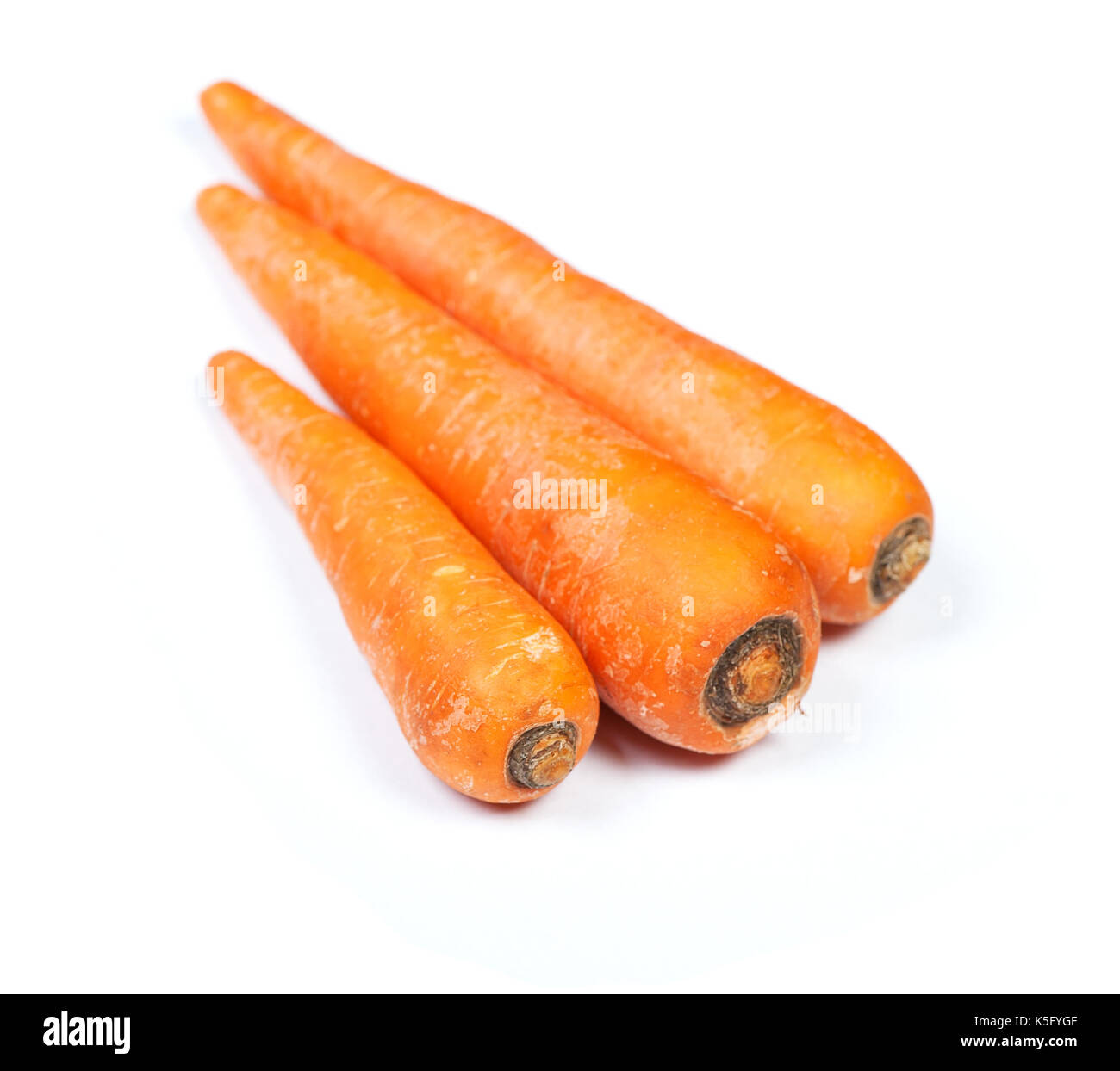 Three carrots isolated on white background Stock Photo - Alamy