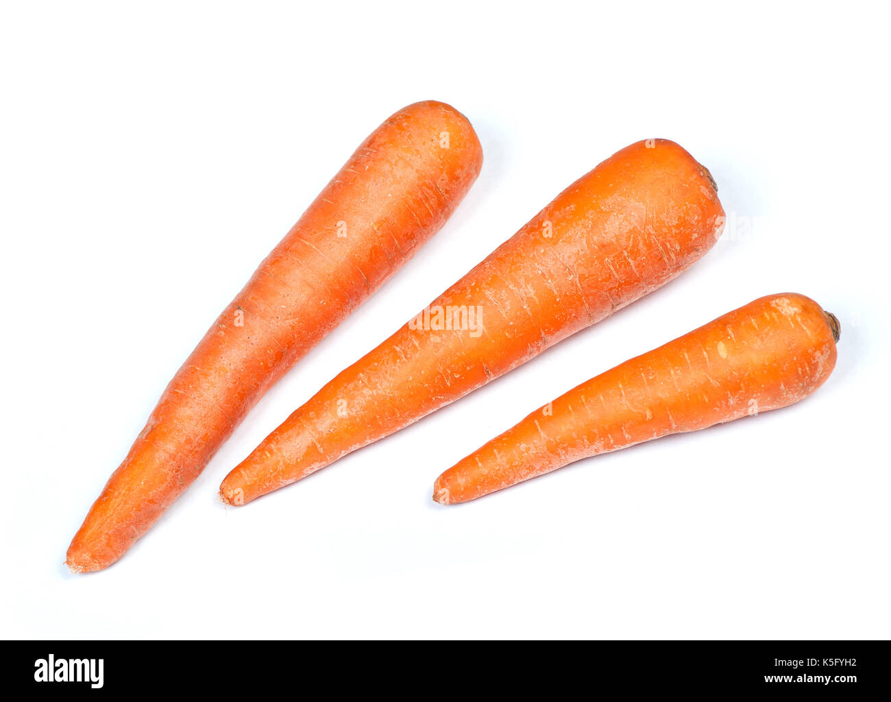 Three carrots isolated on white background Stock Photo - Alamy