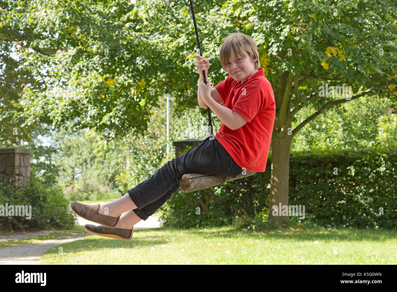 Children swinging on rope hi-res stock photography and images - Alamy