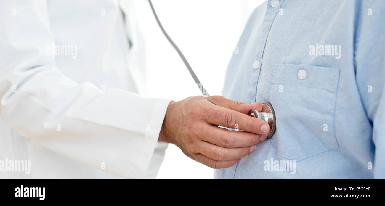 Male doctor using stethoscope, close up Stock Photo - Alamy