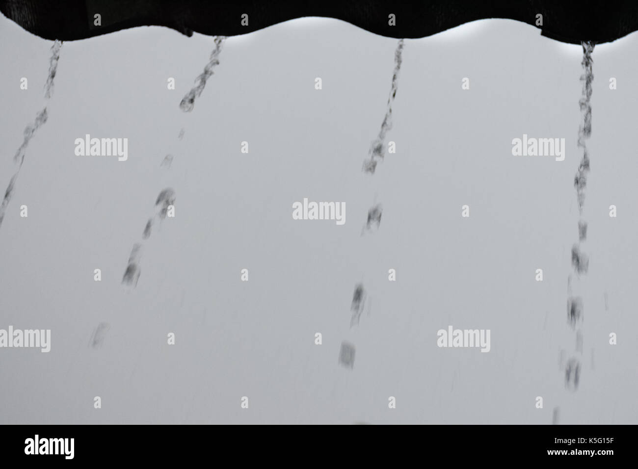 Rain flow pours from the slate roof Stock Photo - Alamy