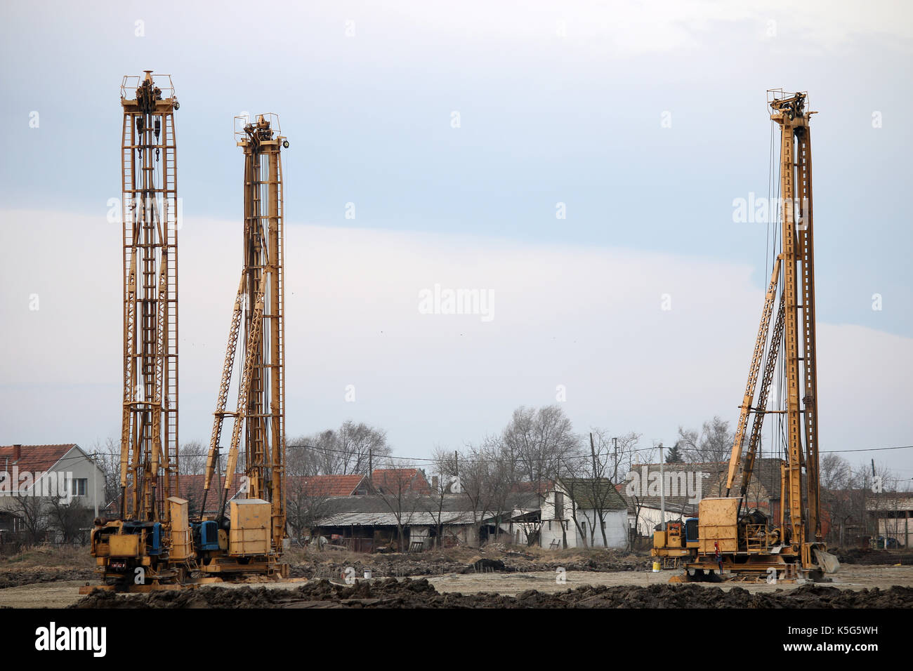 three hydraulic drilling machines on construction site Stock Photo - Alamy